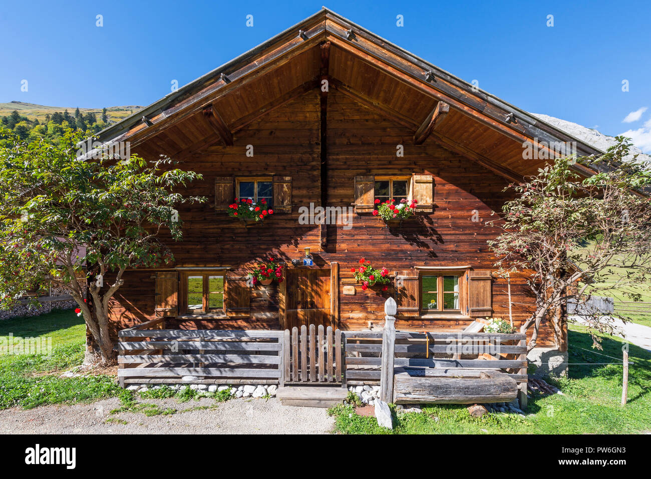 Wooden house with geraniums hi-res stock photography and images - Alamy