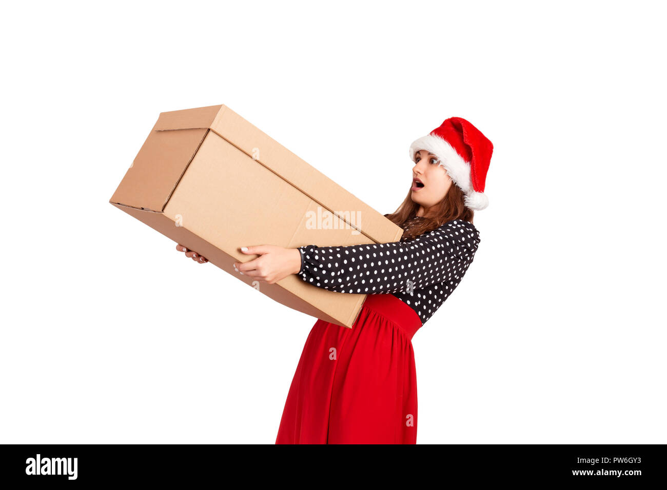 Portrait of excited surprised girl in dress holding big and heavy gift ...