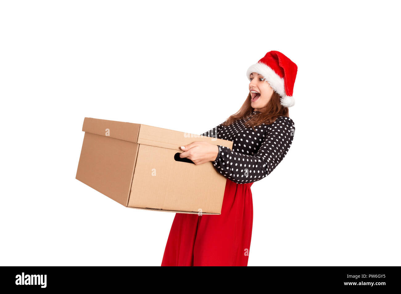 Portrait of excited surprised girl in dress holding big and heavy gift ...