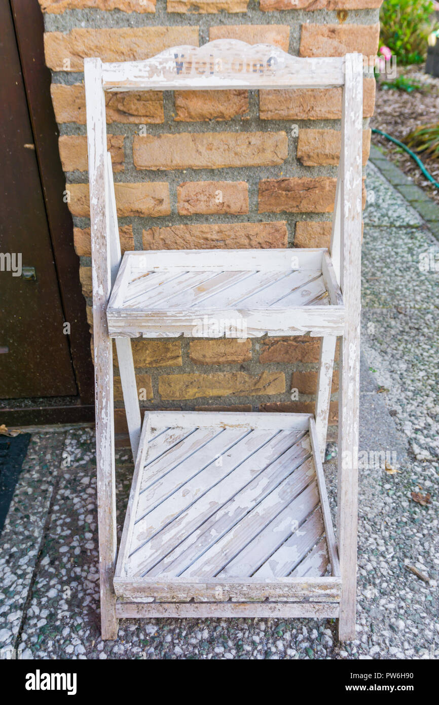 Empty small wooden weathered white cabinet rack with welcome sign ...