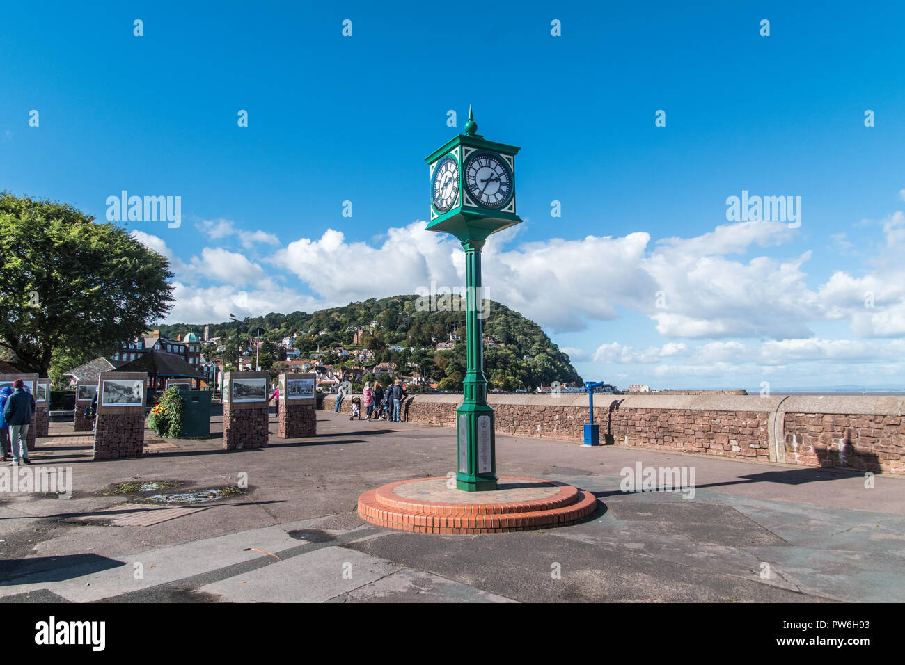 Minehead seafront featuring a clock tower and Selworthy Hill behind ...