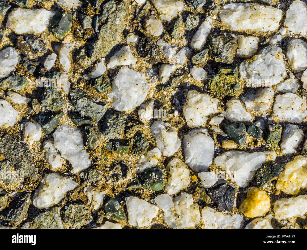 Macro close up texture of a pavement made of all kinds of tiny rocks ...