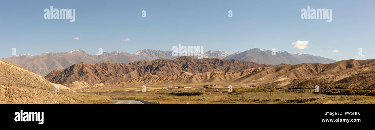 Panorama of houses along road through Chu River Valley gorge in rural ...