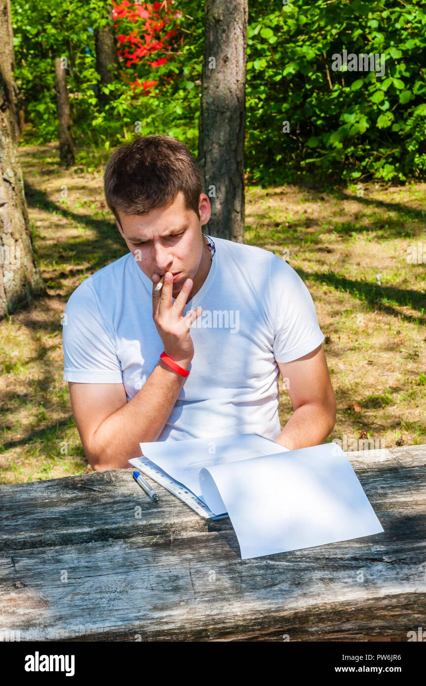 deep thinking guy, that sitting on rural wooden bench with table, he ...