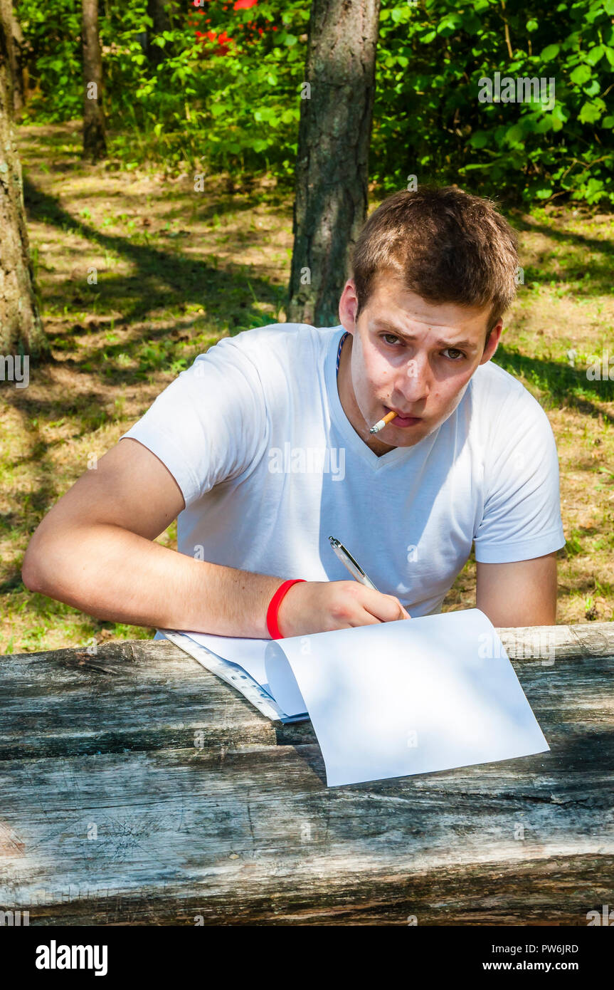 deep thinking guy, that sitting on rural wooden bench with table, he ...