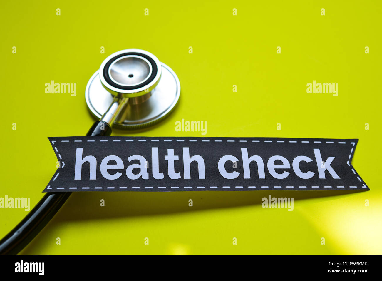 health check with stethoscope concept inspiration on yellow background ...