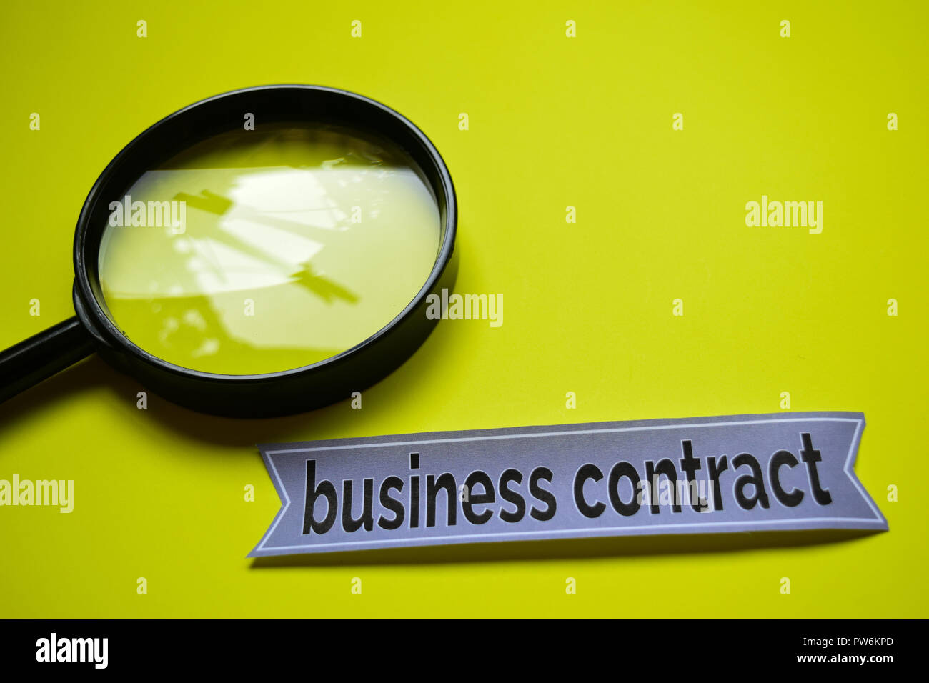 Business Contract with Magnifying glass concept inspiration on yellow ...
