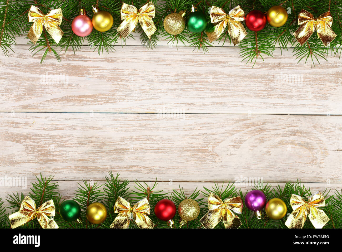 Christmas frame made of fir branches decorated with balls and bows on a ...