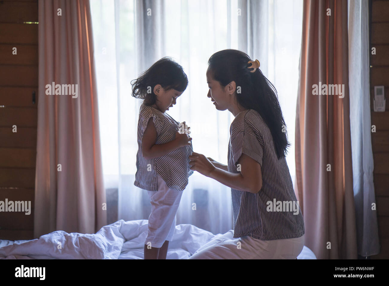 asian woman and daughter prepared clothes Stock Photo - Alamy