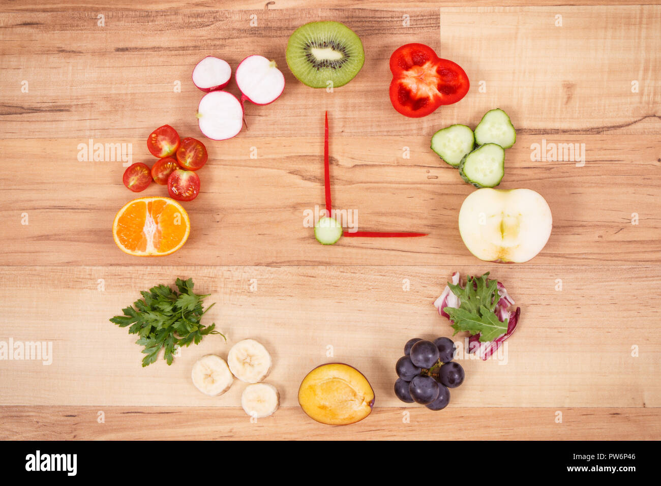 Fresh ripe fruits and vegetables in shape of clock, concept of time for ...