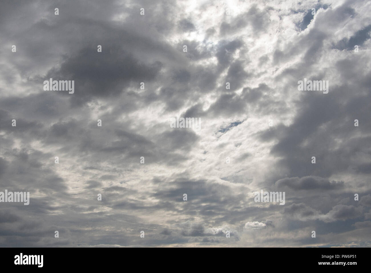 sun blocked by cloud covering on a nice sunny day Stock Photo - Alamy