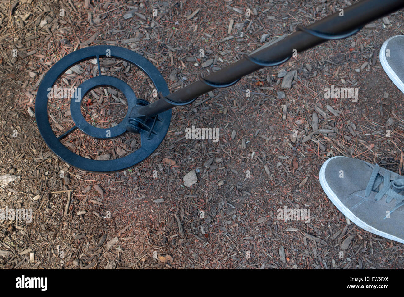 scanning the park grounds of lost metal iteams with a metal detector ...