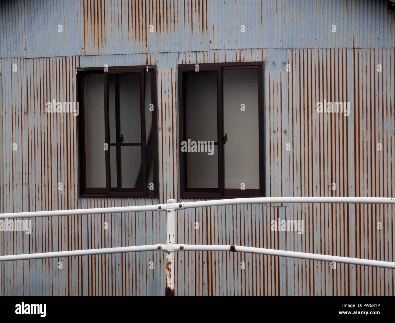 Corrugated iron, rusty, with black metal windows, abstract design ...