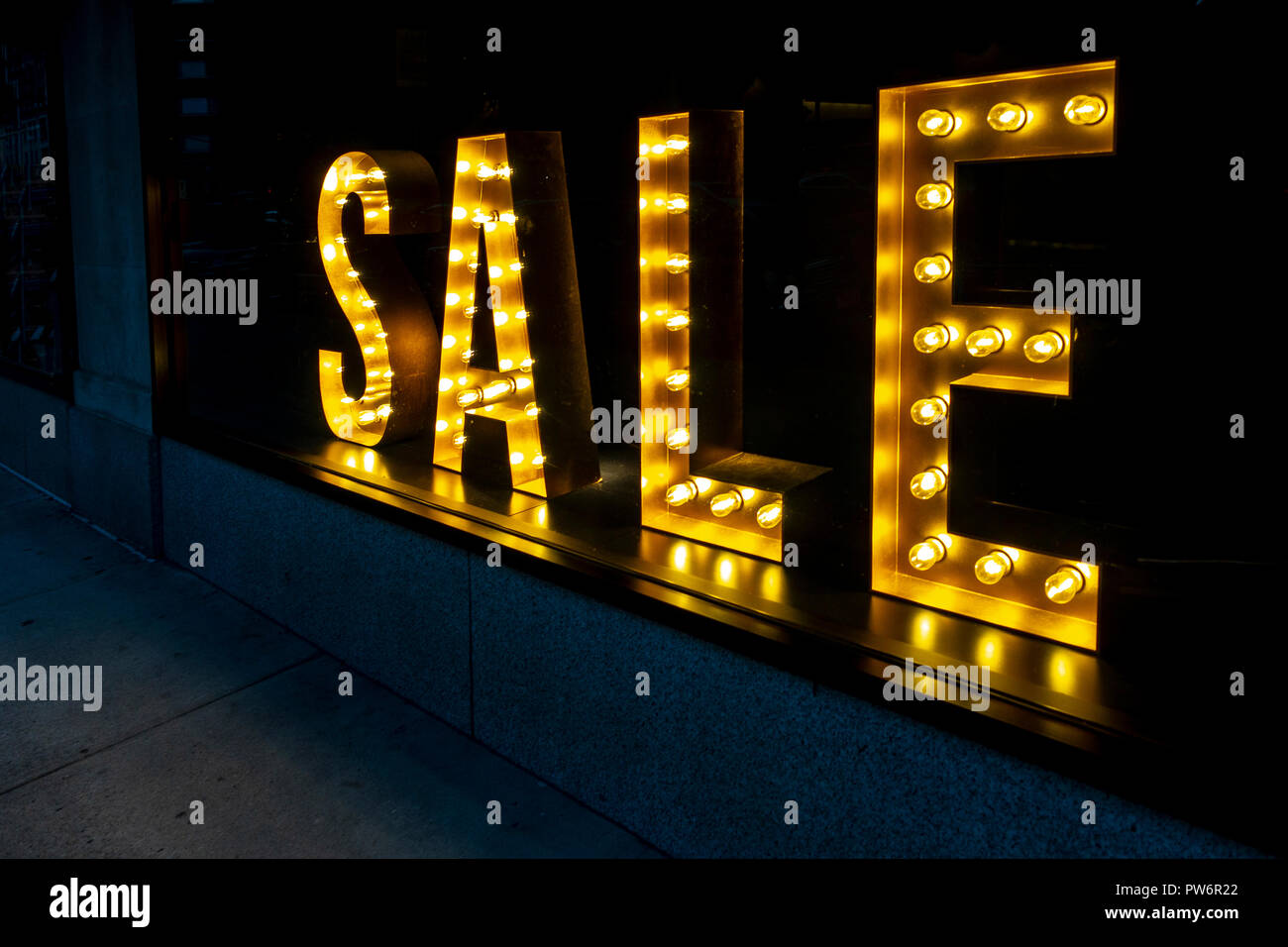 sale sign letters in a store front big and bright at night Stock Photo ...