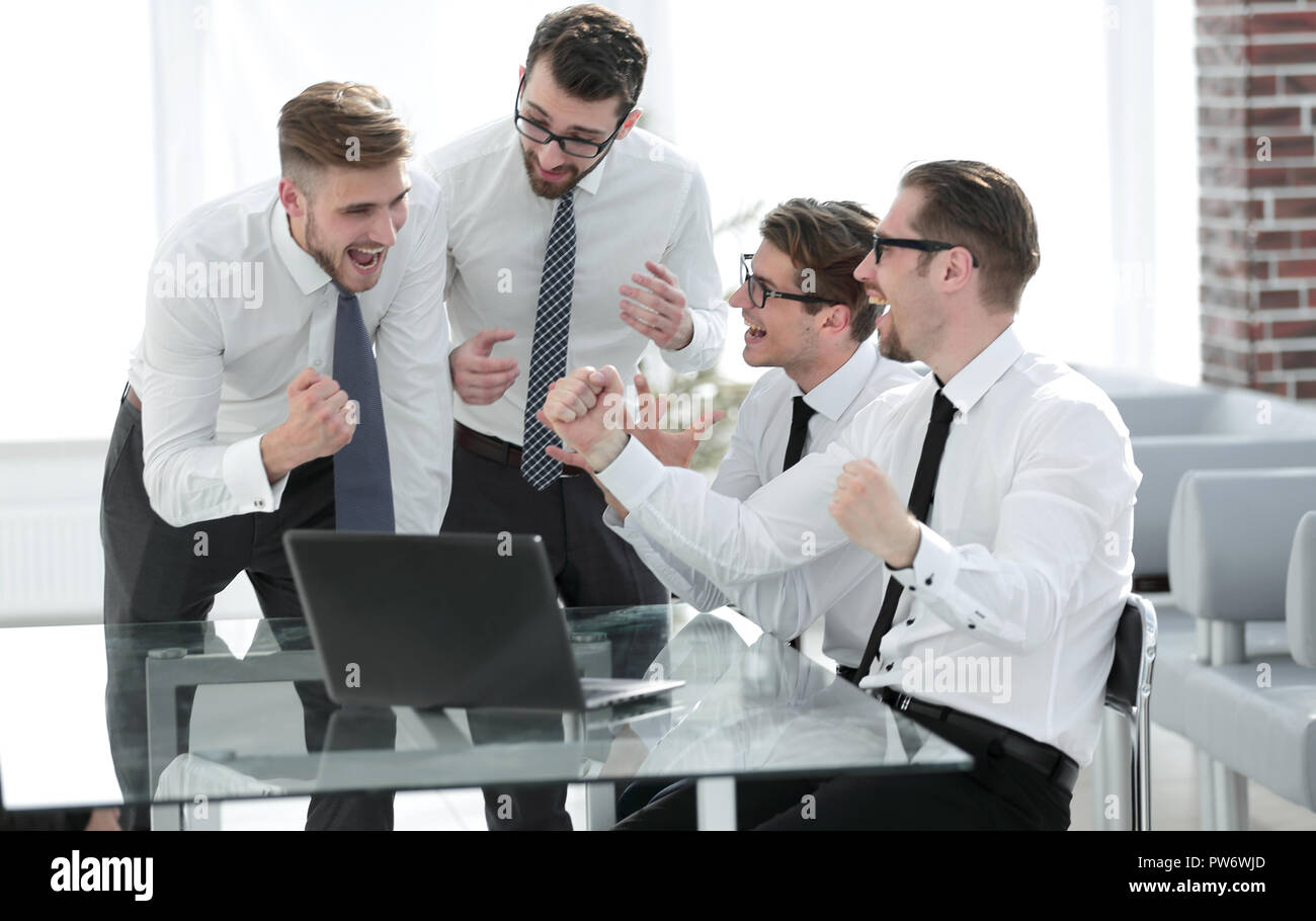 very happy business team standing near the desktop Stock Photo - Alamy