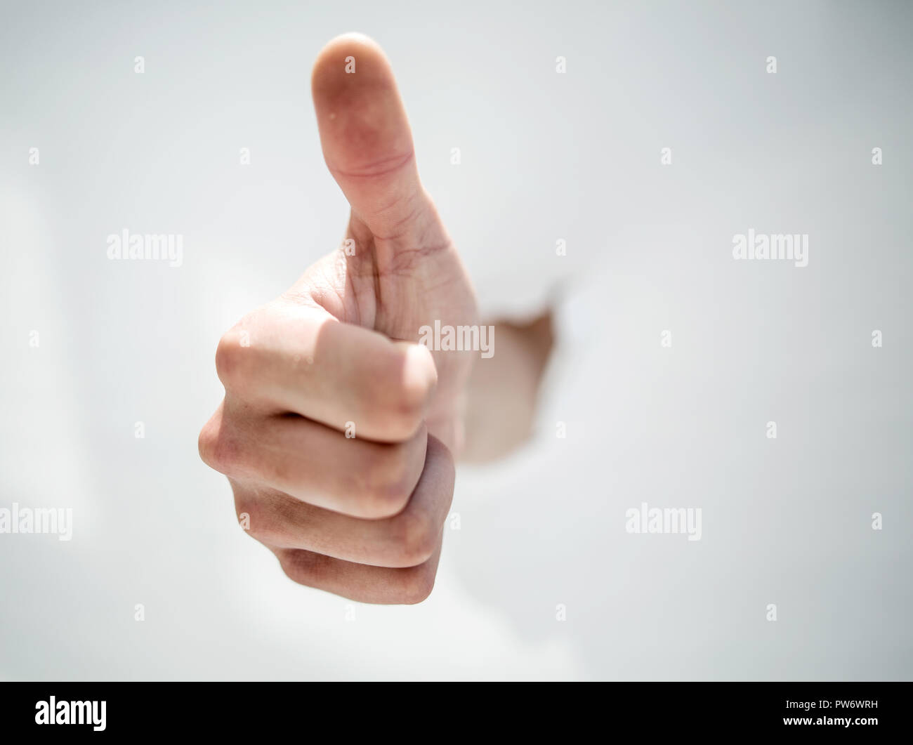 close up.a man's hand breaking through the paper and pointing so Stock ...