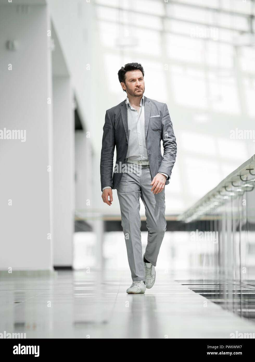 business man walking in the business center Stock Photo - Alamy
