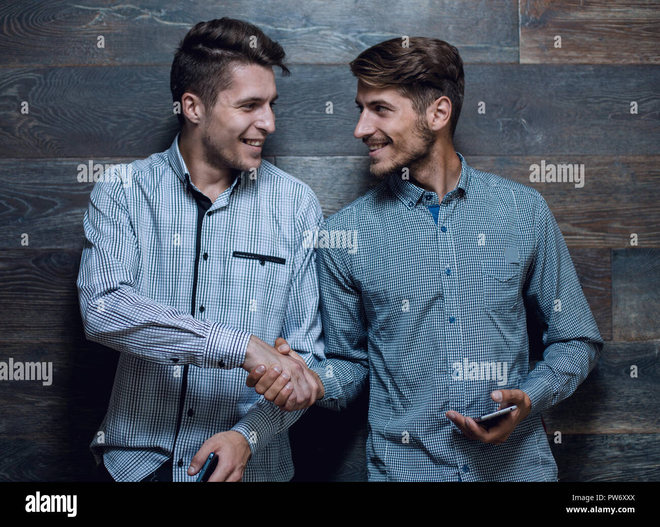 Happy men standing together Stock Photo - Alamy