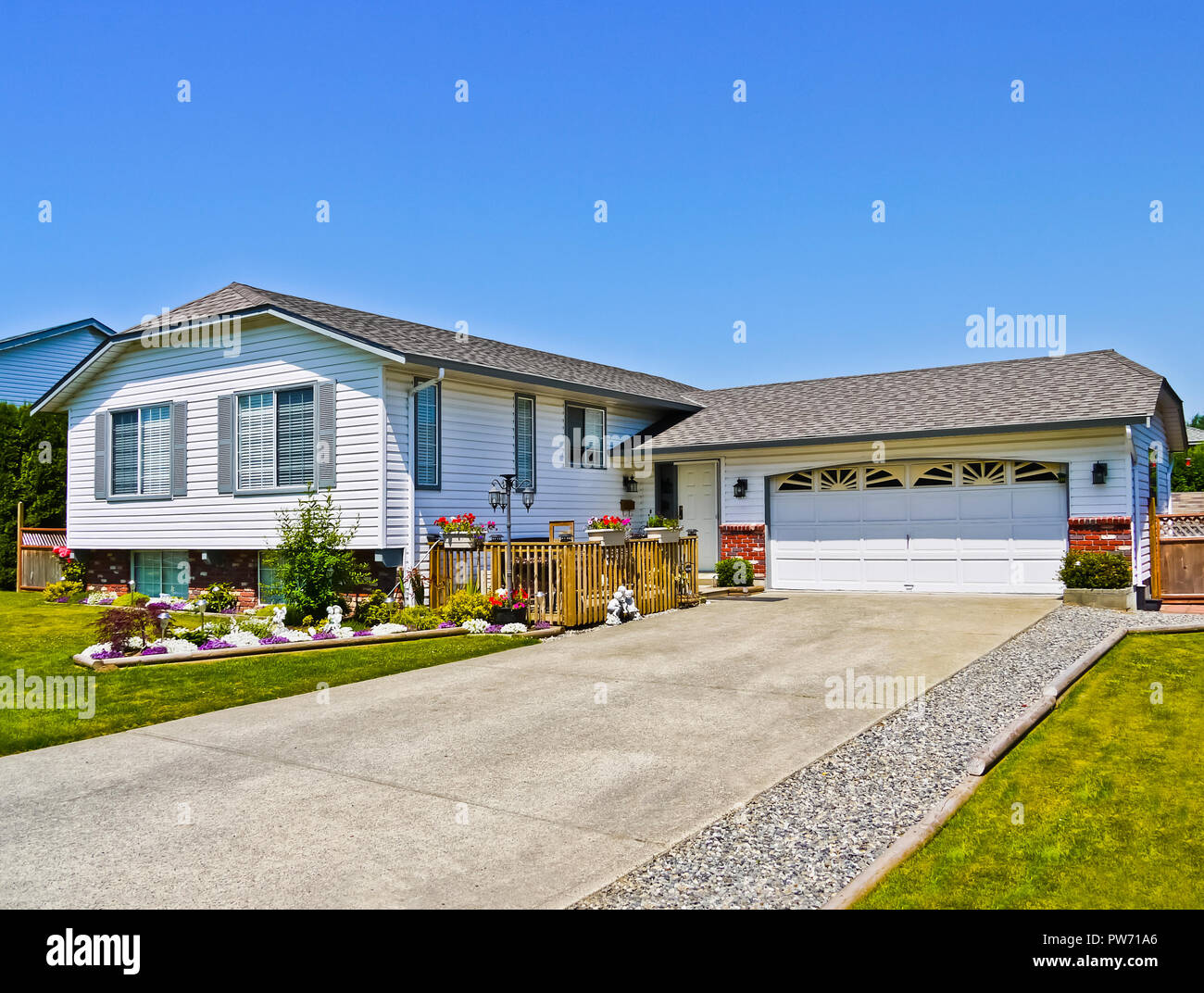 Average residential house with wide garage and concrete driveway on ...