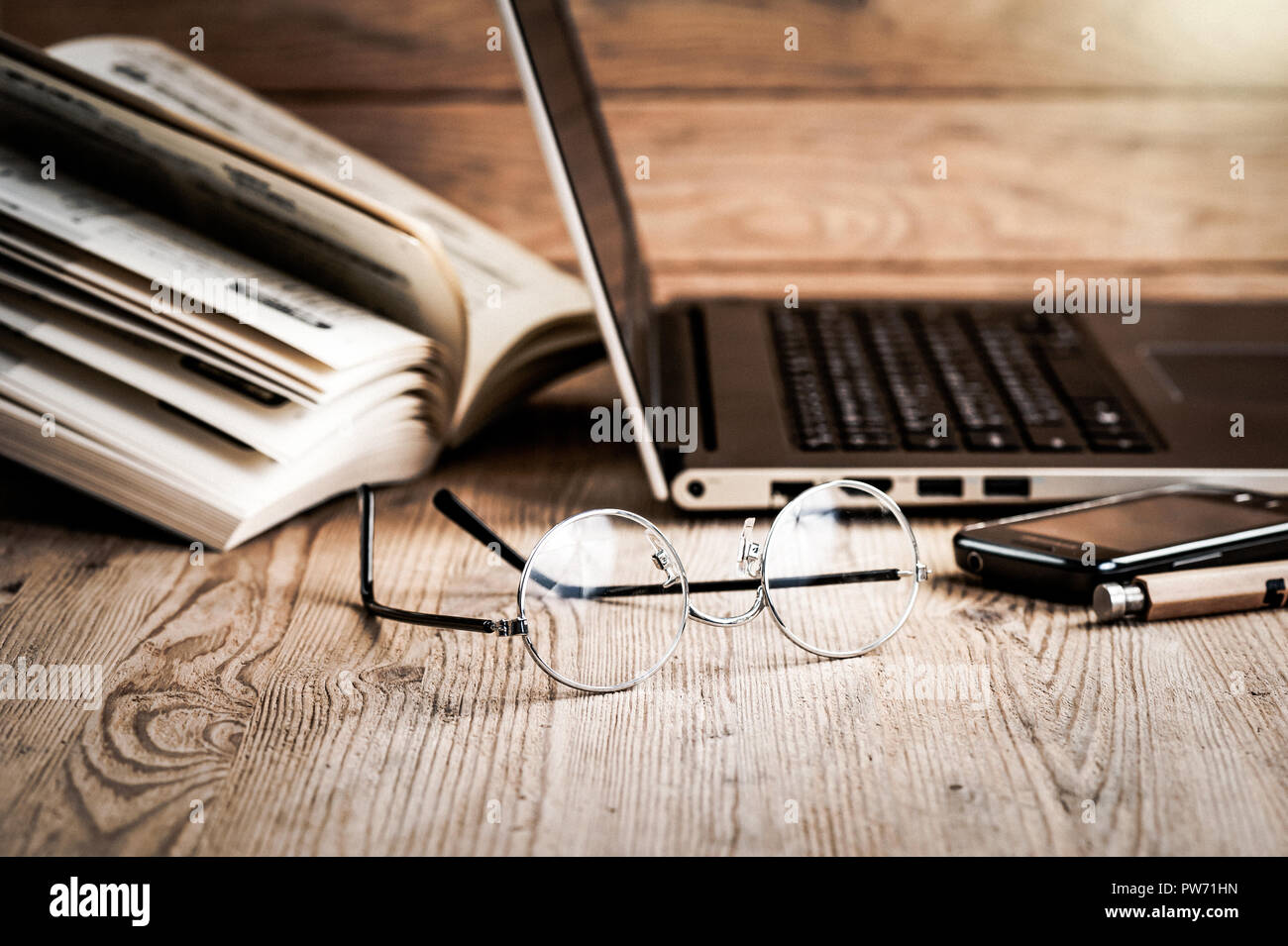 closeup round frame style of eyeglasses on wooden desk, shallow depth ...