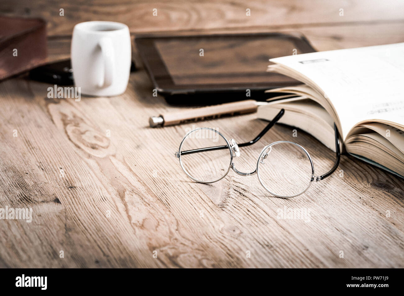 closeup round frame style of eyeglasses on wooden desk, shallow depth ...