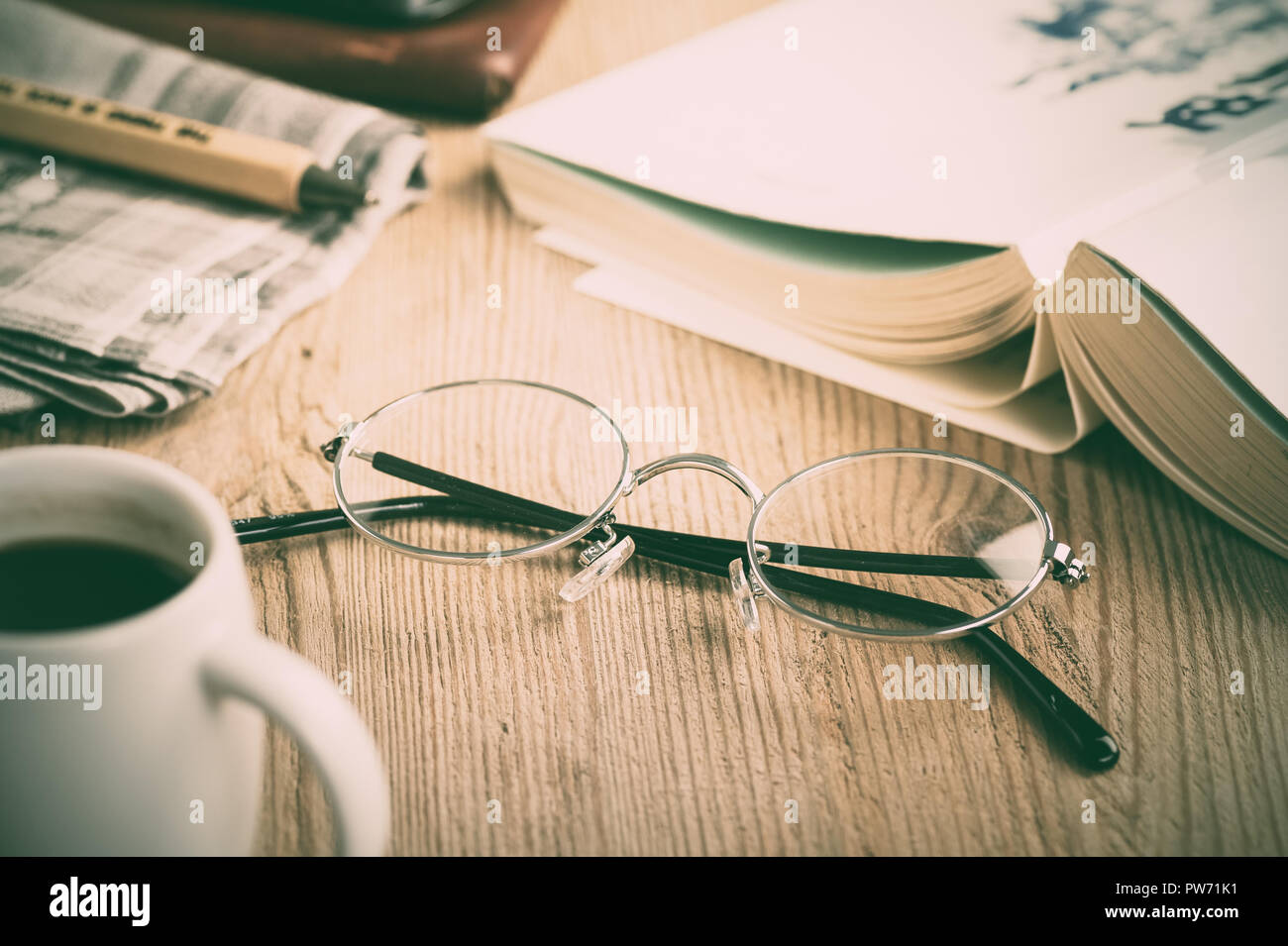 closeup round frame style of eyeglasses on wooden desk, shallow depth ...