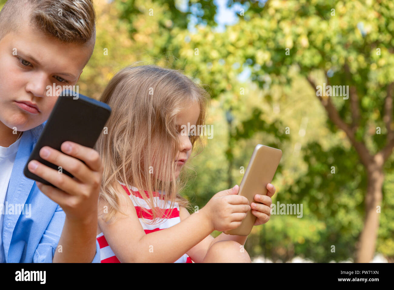 busy kids looking at their phones texting sms and playing sitting ...