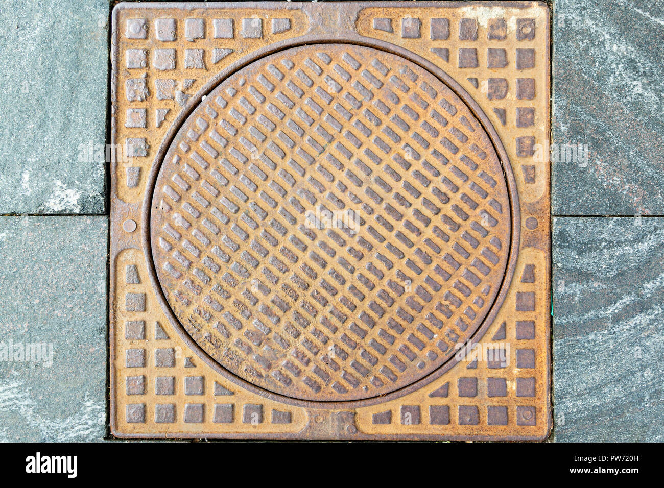Old rusty sewer hatch on an old metal plate. View from above Stock ...