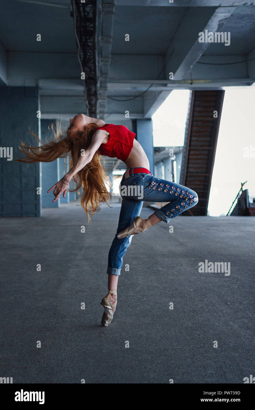 Ballerina dancing in jeans, t-shirt and pointe. Street performance ...