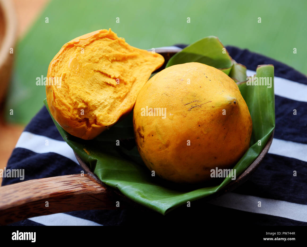 Close up of yellow canistel fruit on green background, also name egg ...