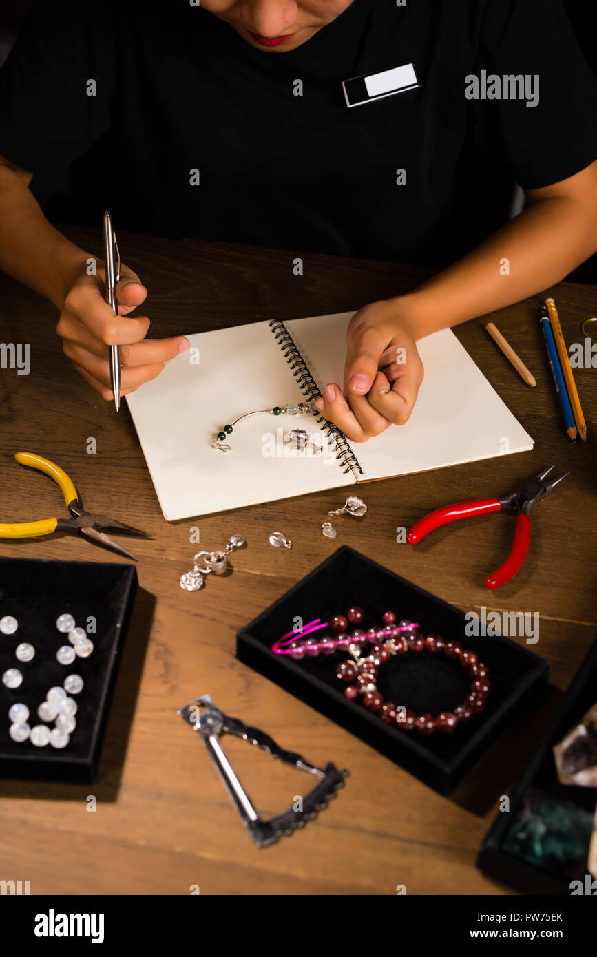Jewelry designer works on a hand drawing sketch Stock Photo - Alamy