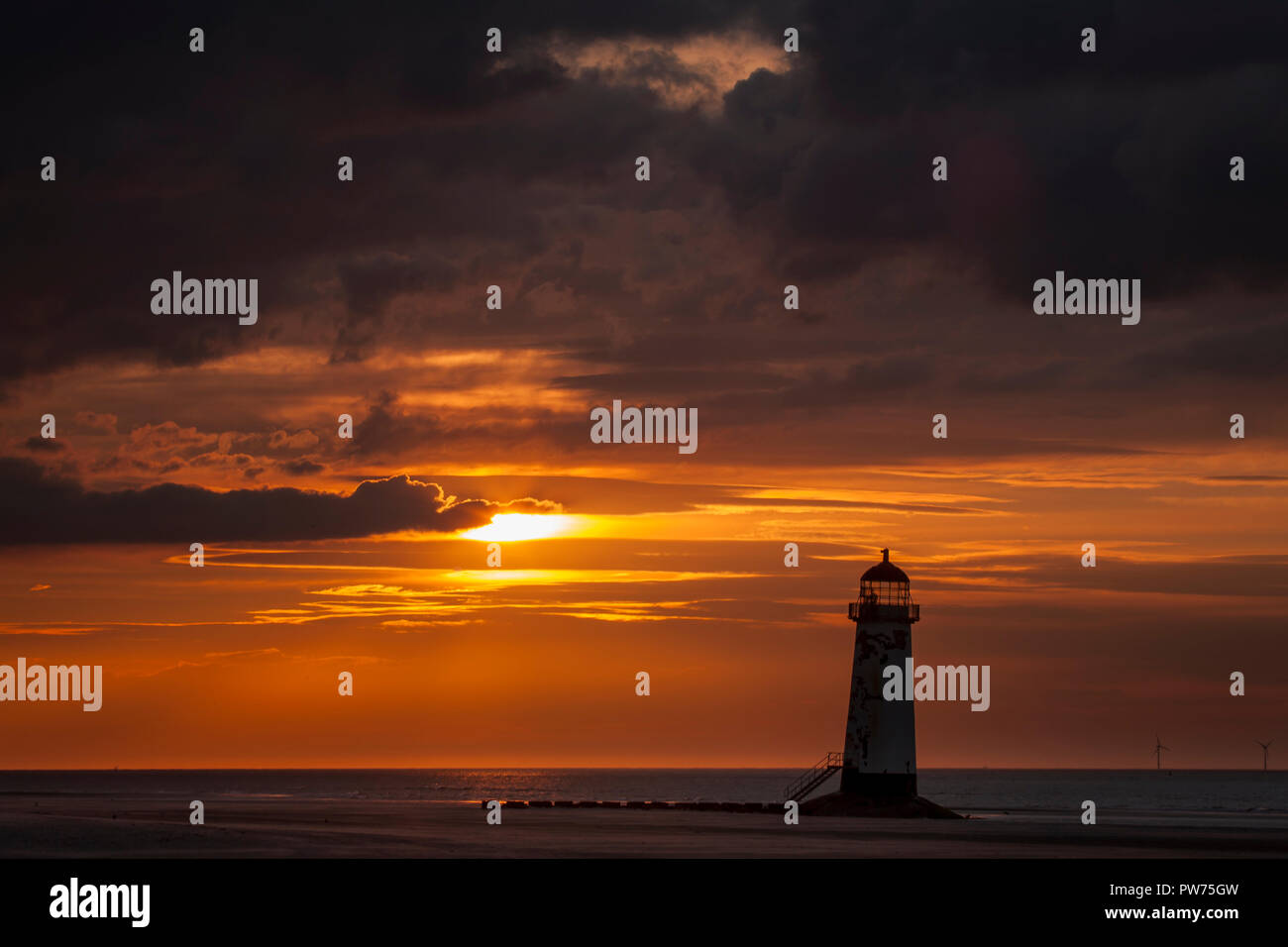 Point of Ayr lighthouse at sunset on Talacre beach, North Wales coast ...