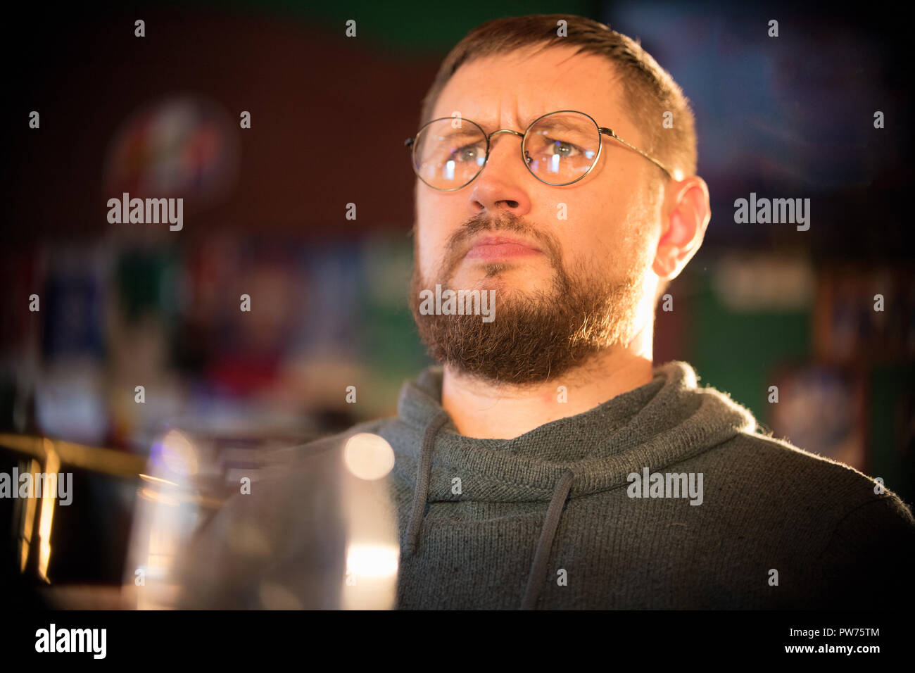 Bearded man in glasses looking perplexity. Irish pub. Portrait Stock ...