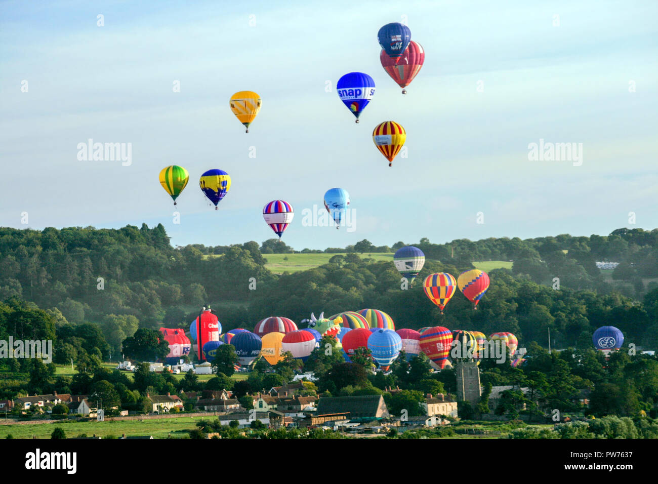 Hot air balloons taking to the sky in the early morning during the ...