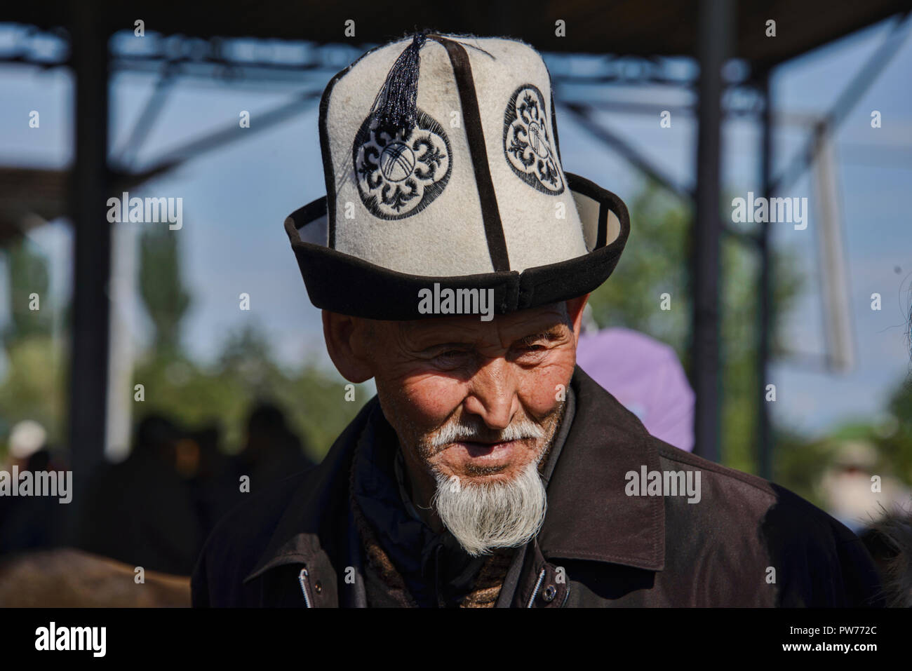 Man with kalpak hat in the bazaar, Sary Mogul, Kygyzstan Stock Photo ...