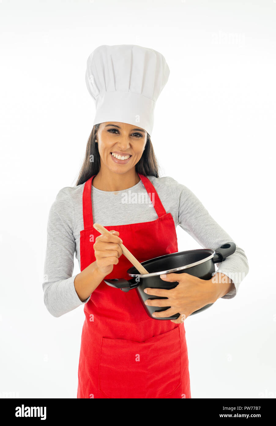 Portrait of cooking woman stirring with wooden spoon in pot making ...