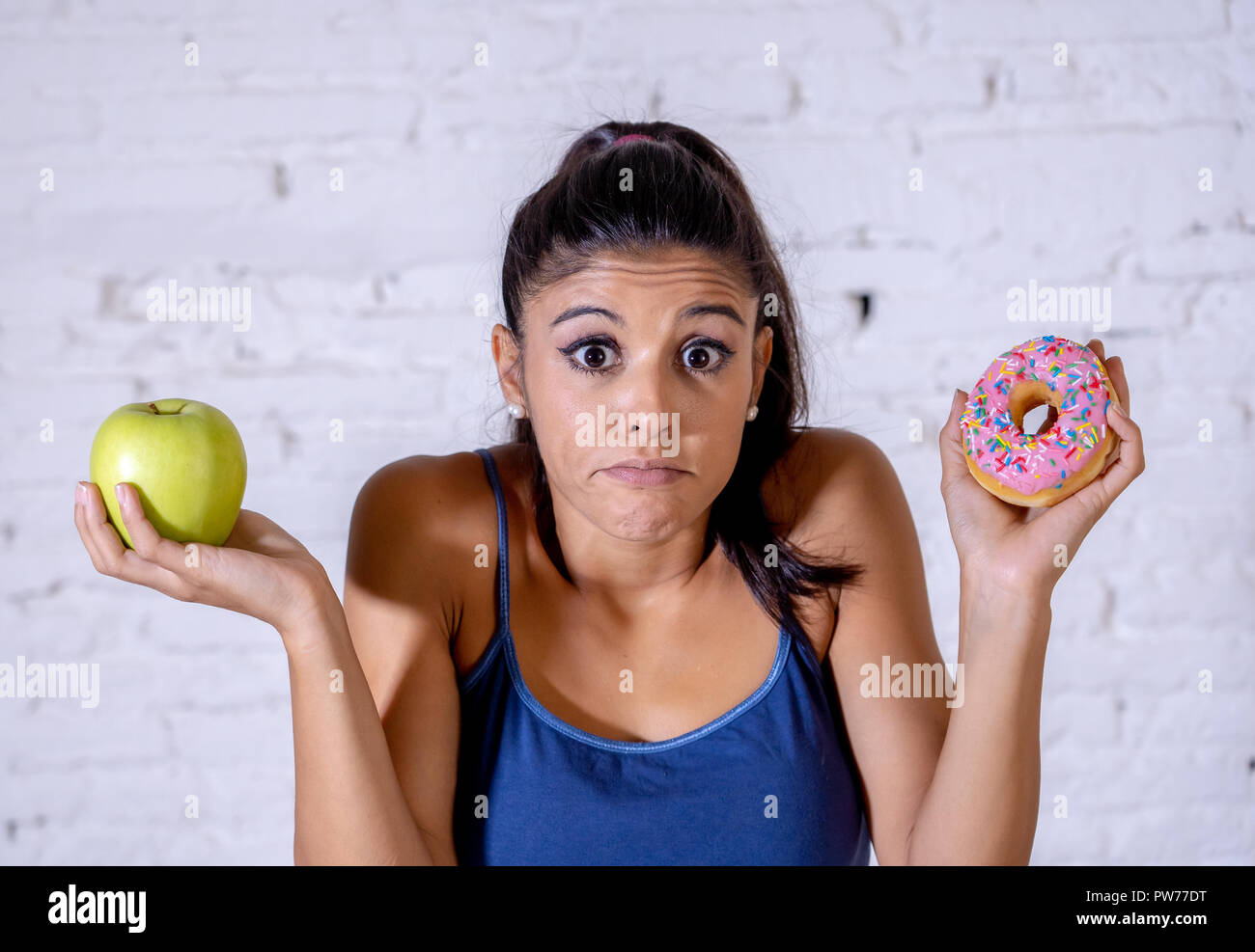 Young woman tempted junk food hi-res stock photography and images - Alamy