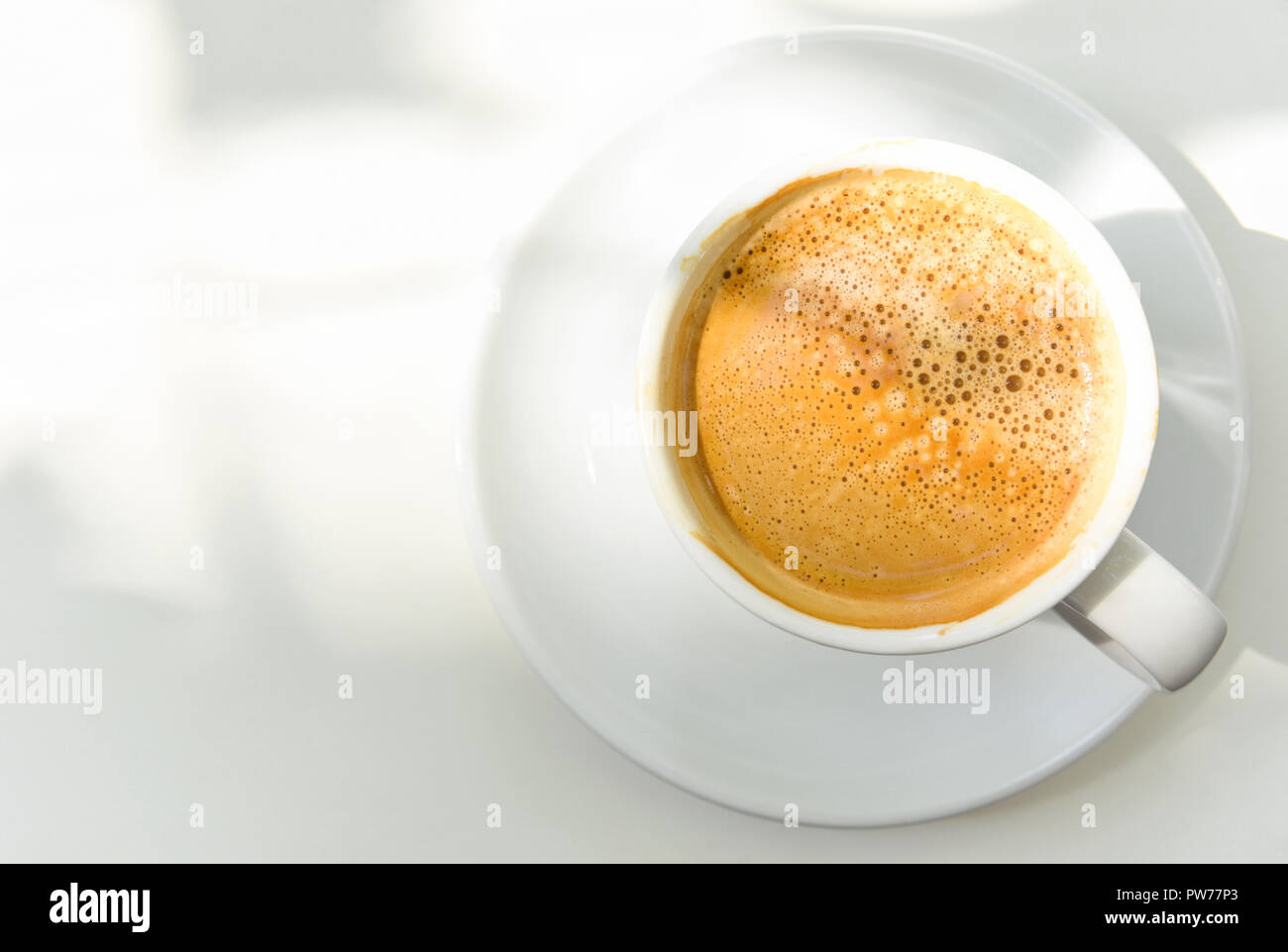 White Cup of Freshly Brewed Coffee on Saucer Table Sunlight Leaks. Top ...