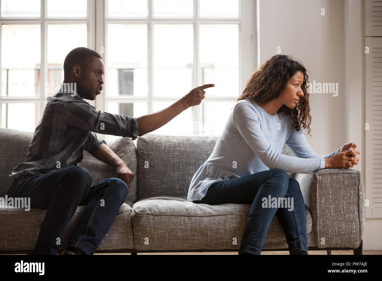 Black woman and man quarrelling at home Stock Photo - Alamy