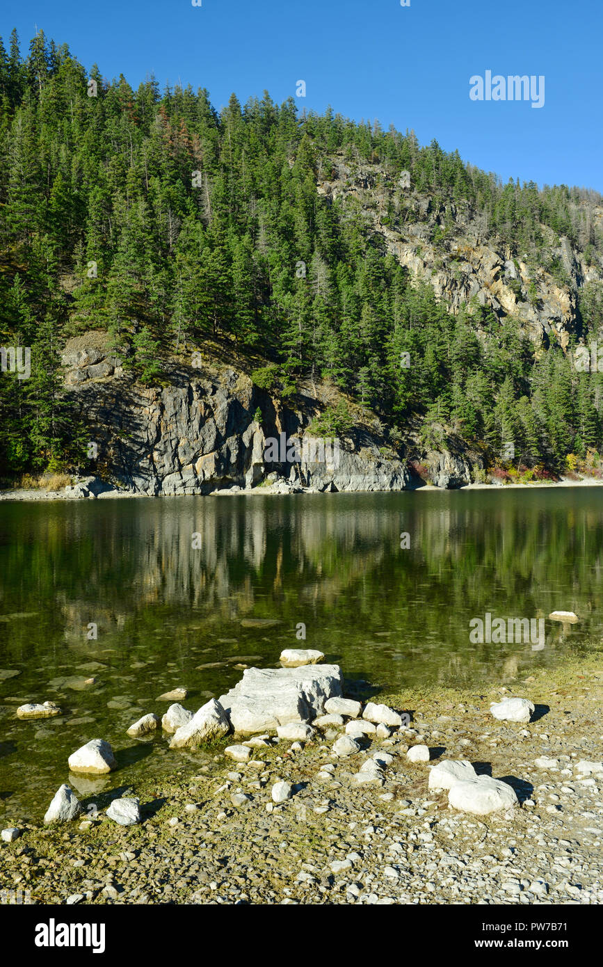 Rock cliffs reflected in Crown Lake, British Columbia, in the Marble ...