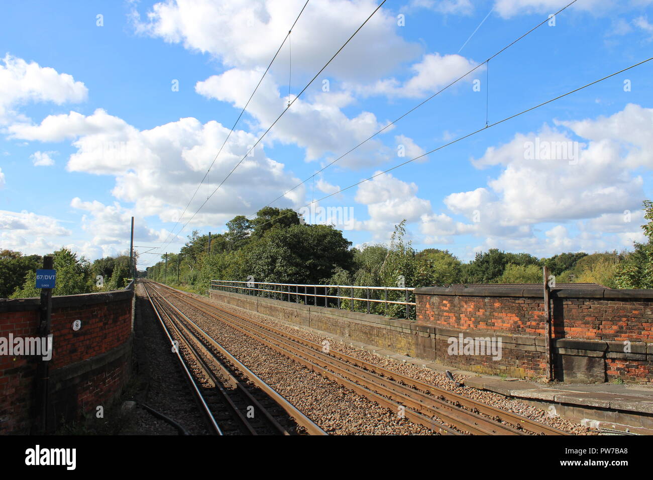 Railway tracks at a train station on a summer's day Stock Photo - Alamy