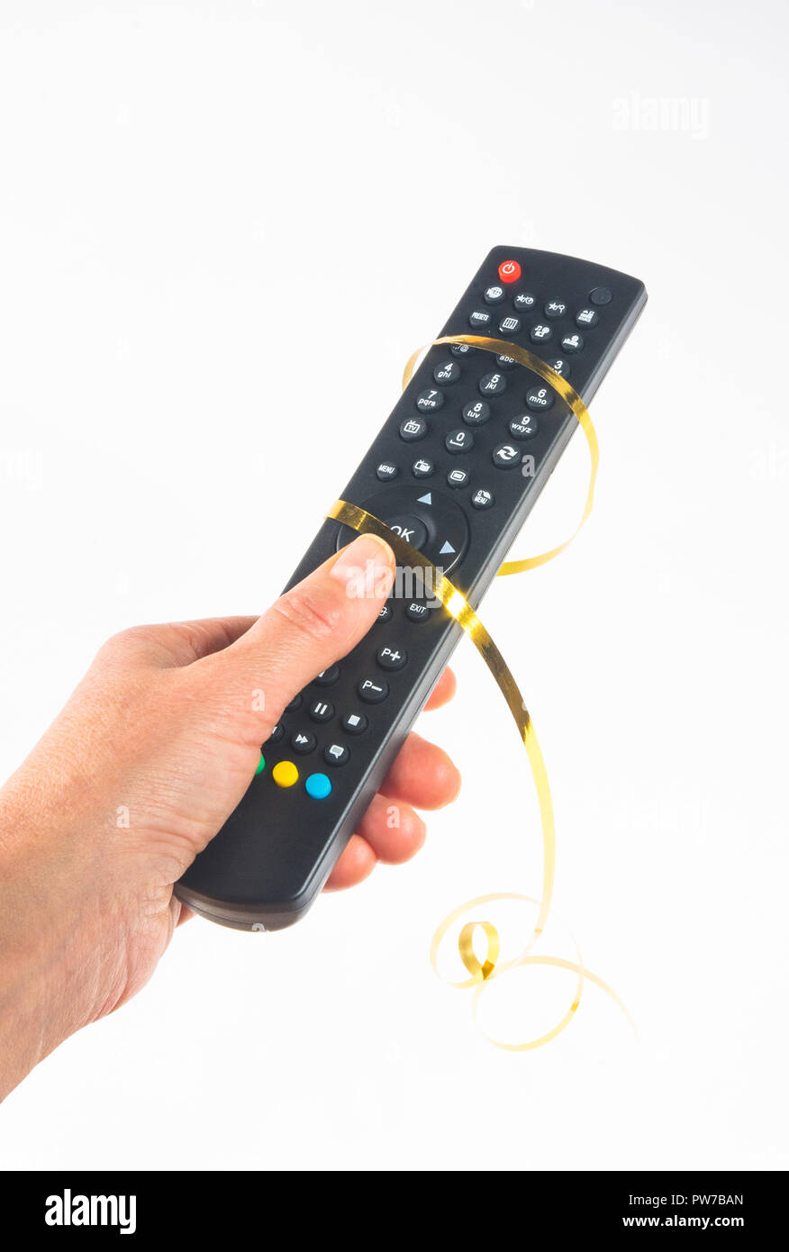 hand holding a remote control in a festive gold ribbon on white ...
