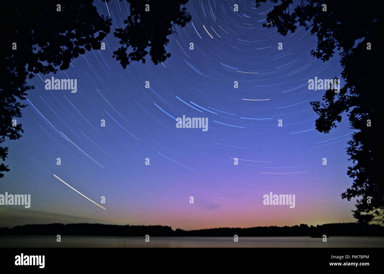 Long exposure star trails, rotating around the North Star. Aurora ...