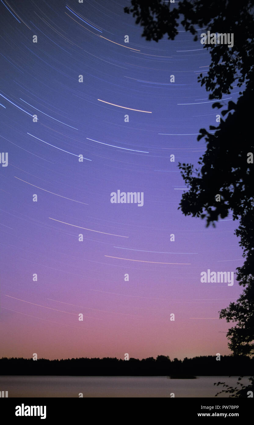 Long exposure star trails, rotating around the North Star. Aurora ...