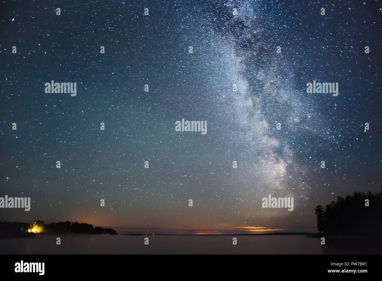 Milky way and stars above lake Stock Photo - Alamy