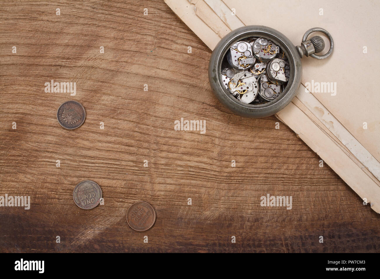 broken vintage pocket watch on wooden background Stock Photo - Alamy