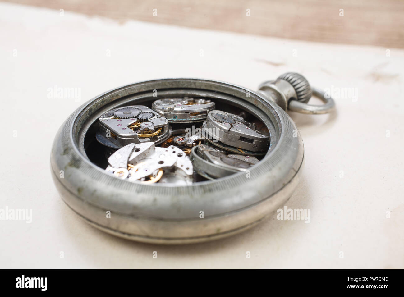 broken vintage pocket watch on wooden background Stock Photo - Alamy