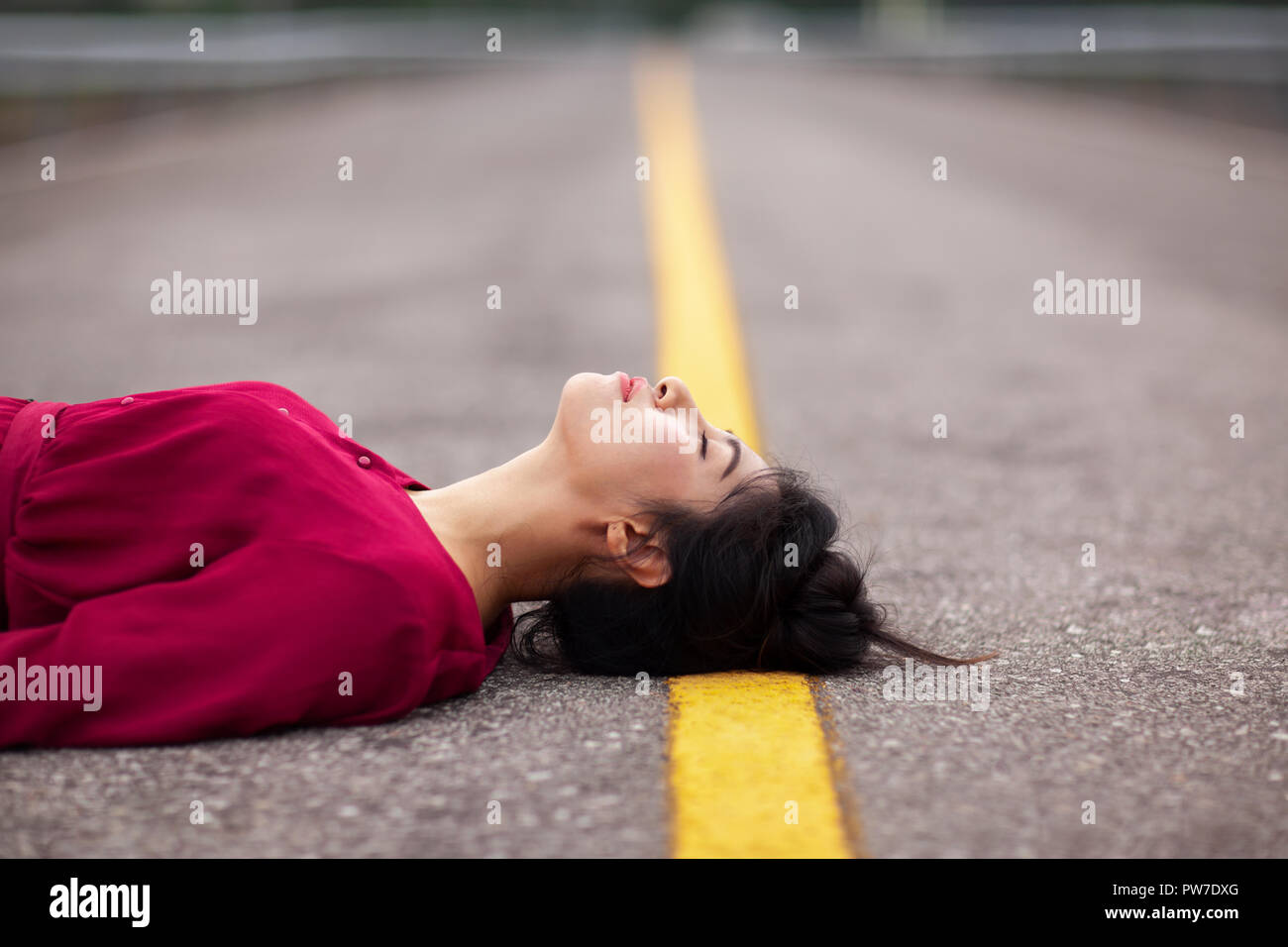 Portrait of beautiful young asian woman in Carmen red dress lying on ...