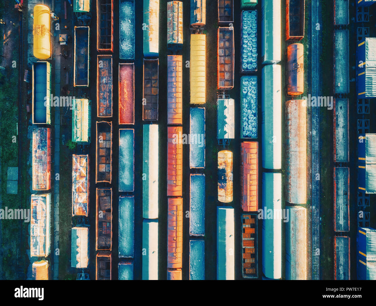 Aerial view of freight trains at sunset. Railway cargo wagons with ...