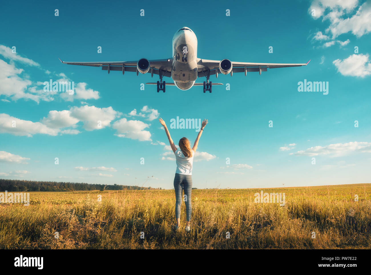 Airplane and woman at sunset. Autumn landscape with girl standing on ...